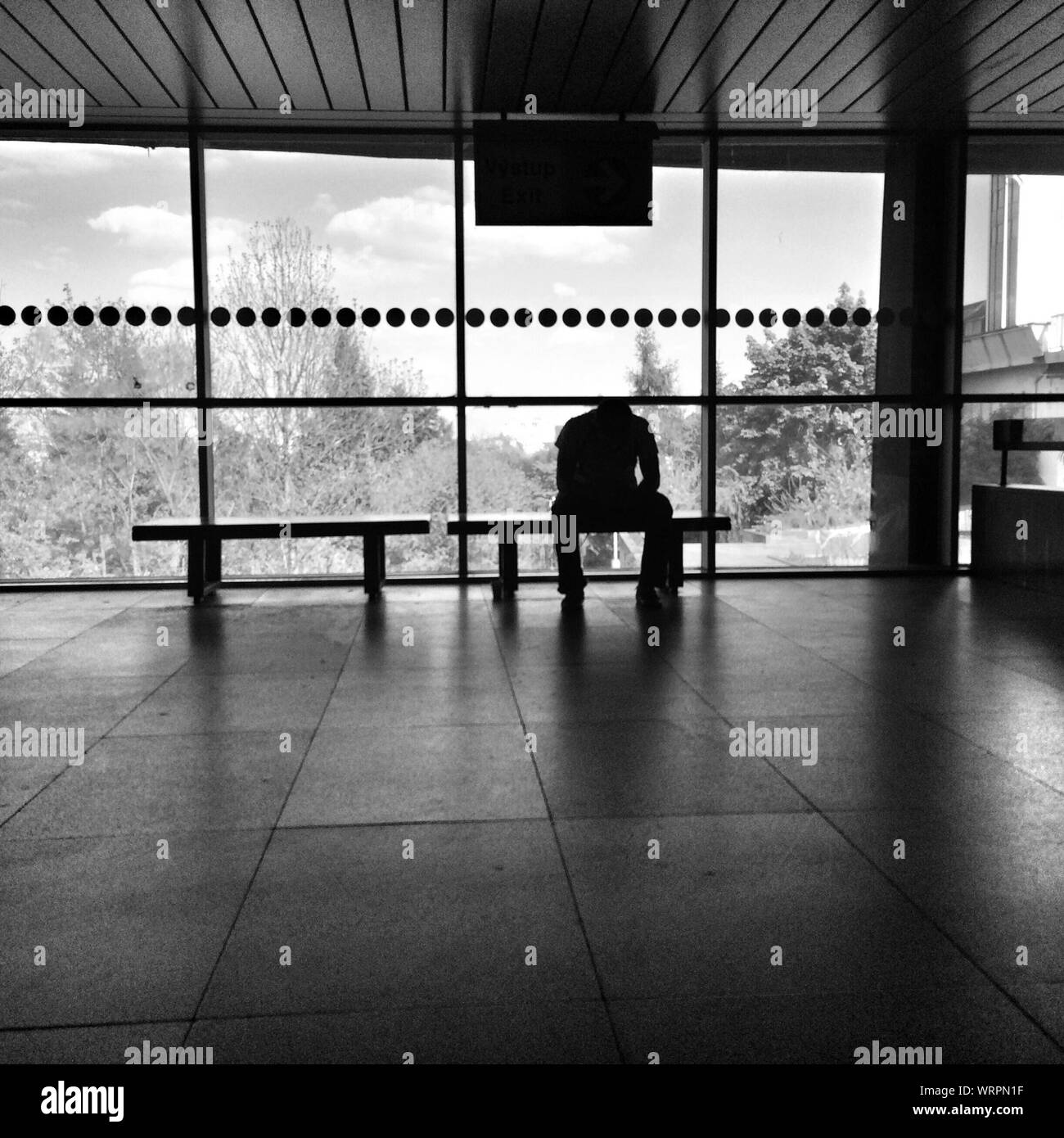 Man sitting in empty hi-res stock photography and images - Alamy