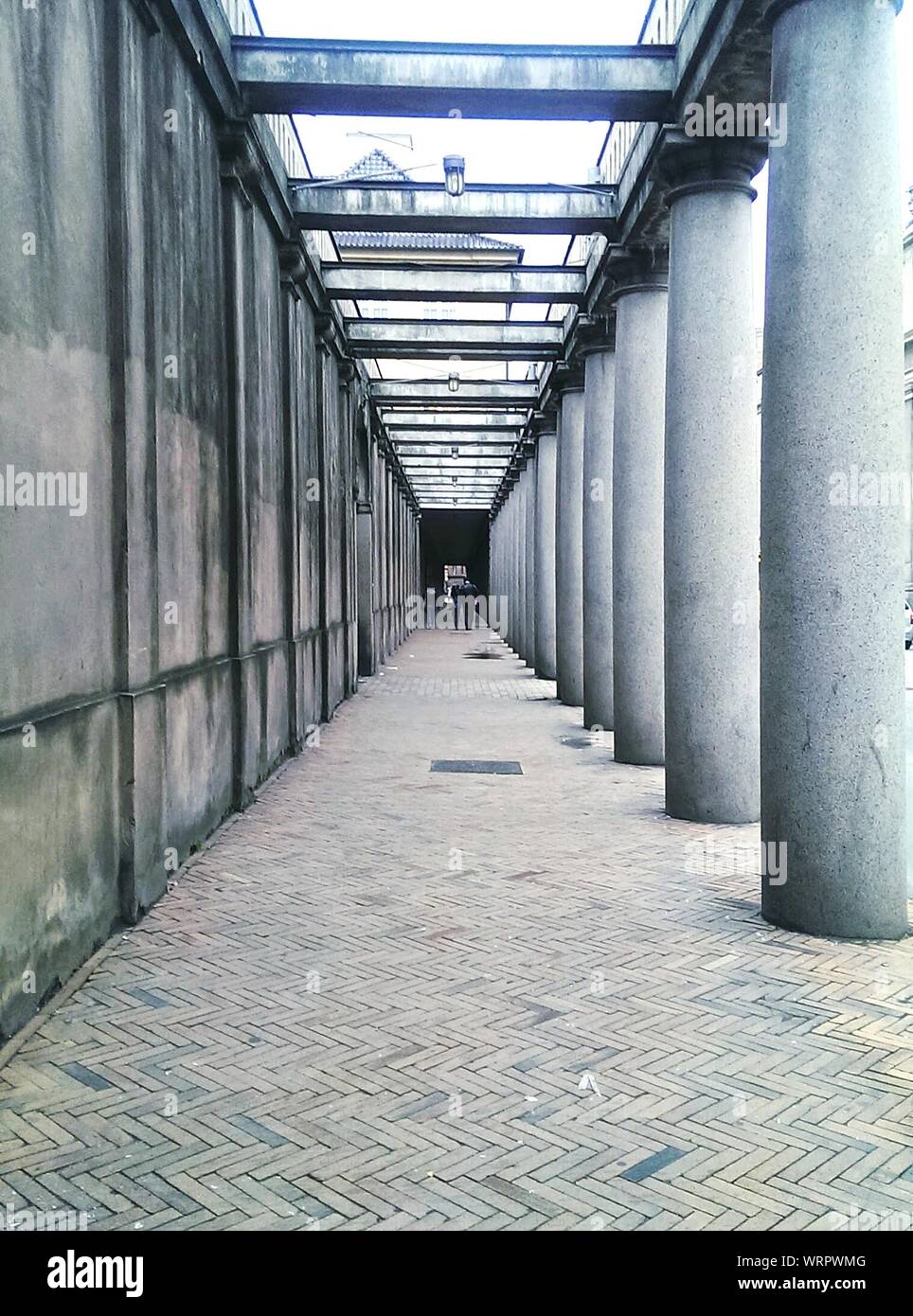 Mid Distance Of People Walking In Corridor Of Building Stock Photo - Alamy
