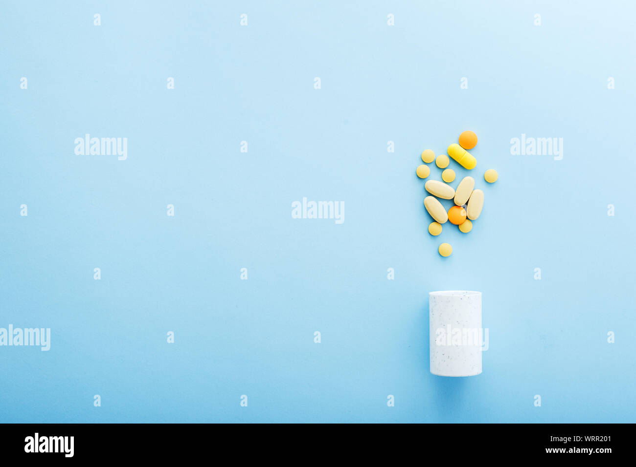 Pharmaceutical medicine pills and bottle on blue background Stock Photo ...
