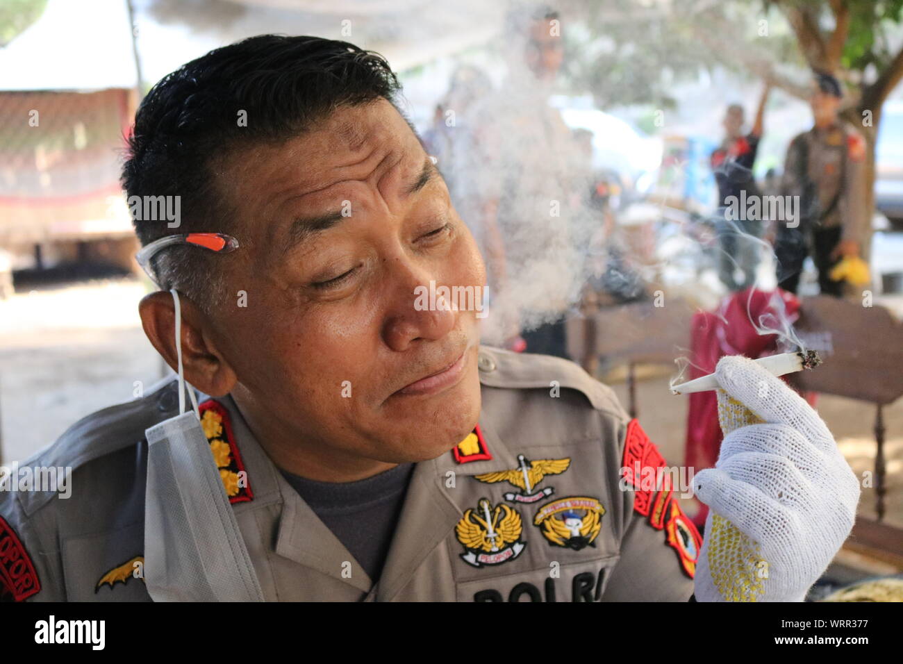 A policeman is trying to smoke tobacco Stock Photo - Alamy