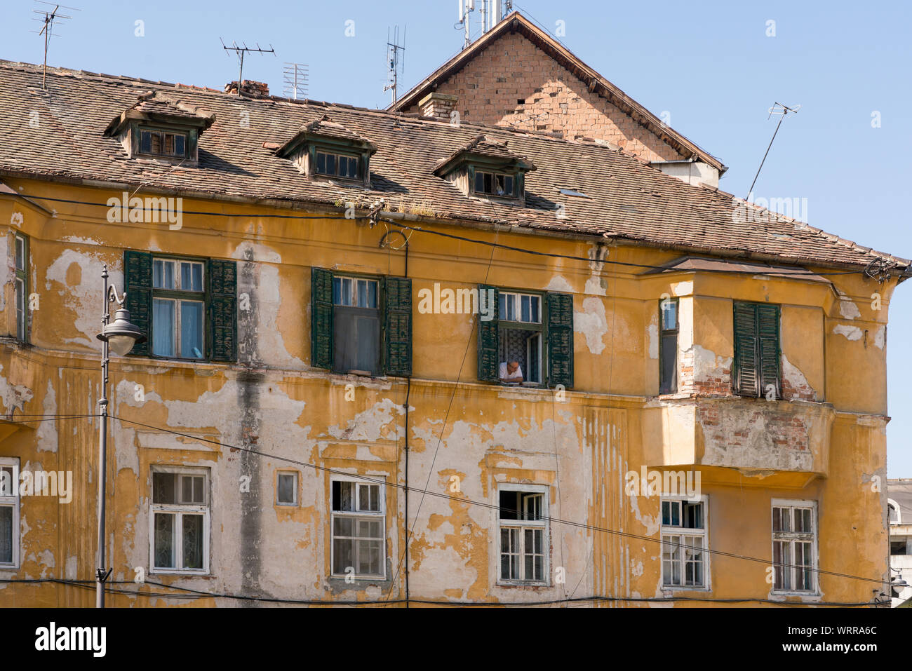 Man looking out of his window Stock Photo - Alamy