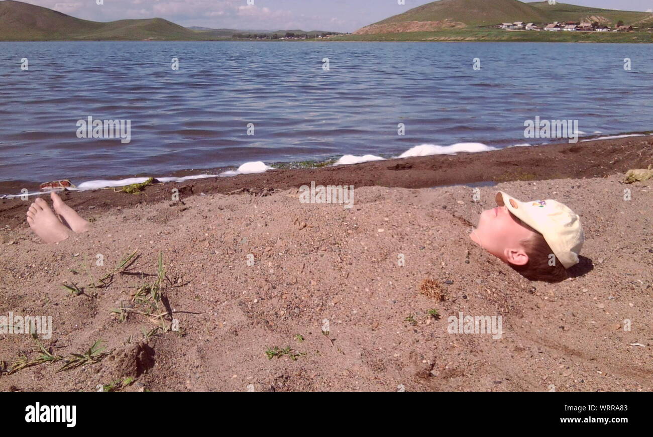 People buried in sand hi-res stock photography and images - Alamy