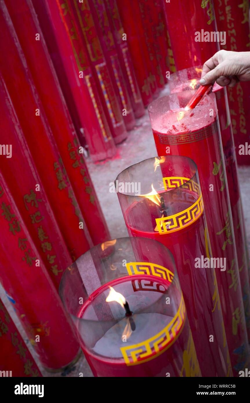 Igniting candles hi-res stock photography and images - Alamy