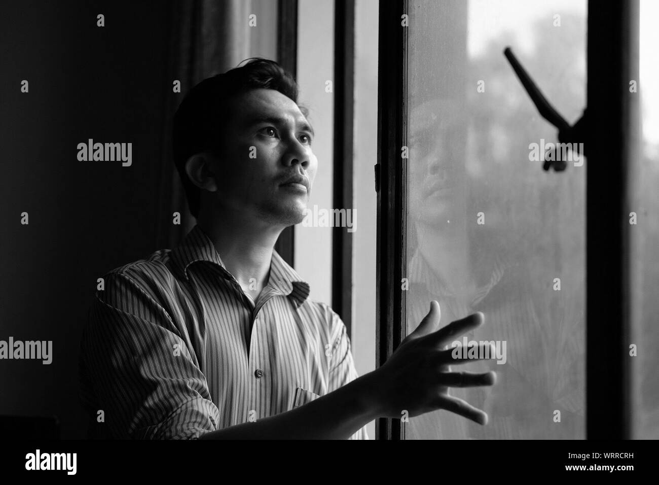 Man office window standing hi-res stock photography and images - Alamy