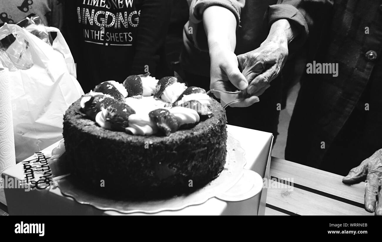 Hand holding cake cake Black and White Stock Photos & Images - Alamy