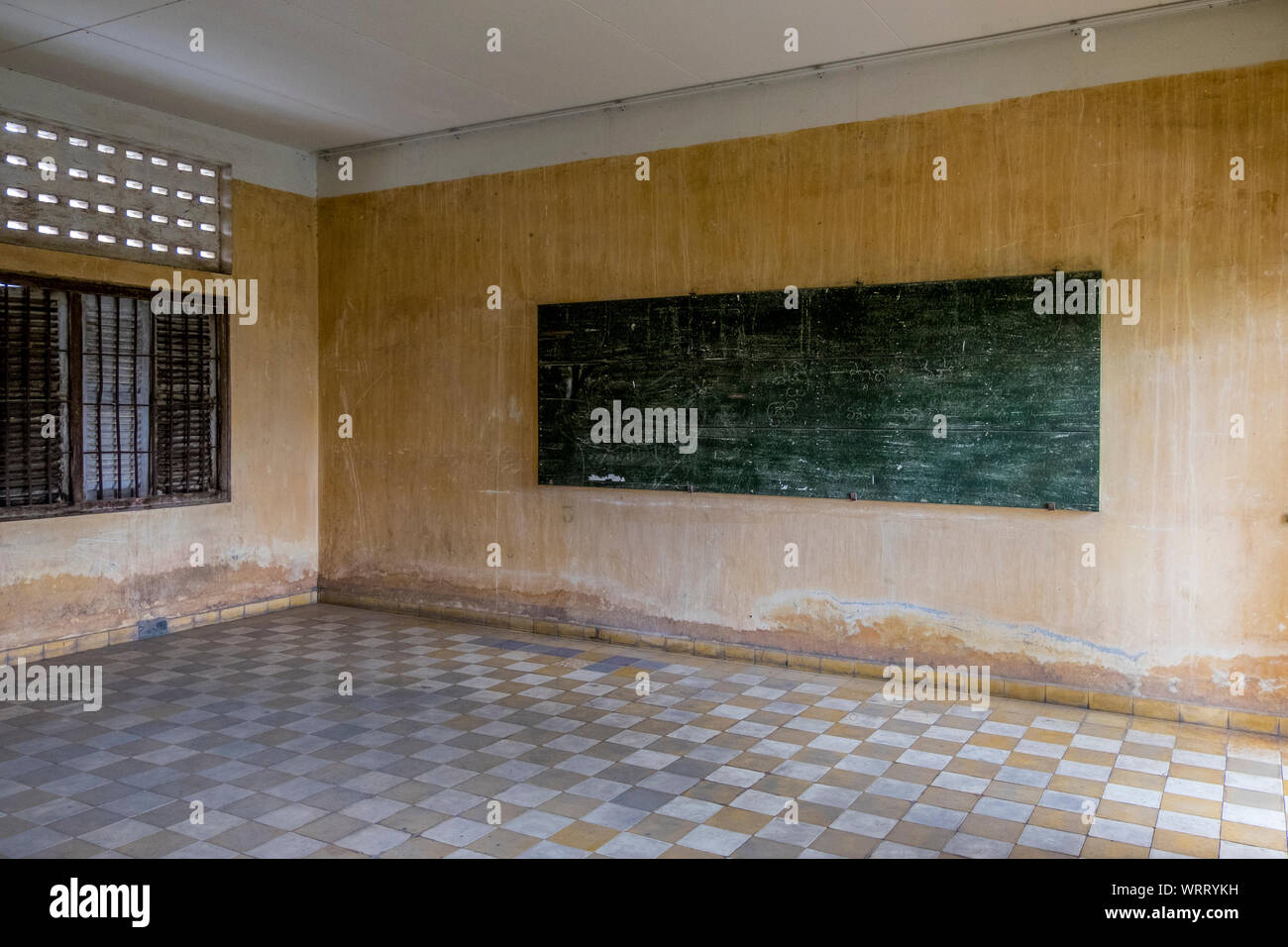 An old chalkboard is still mounted on a wall in a former classroom at ...