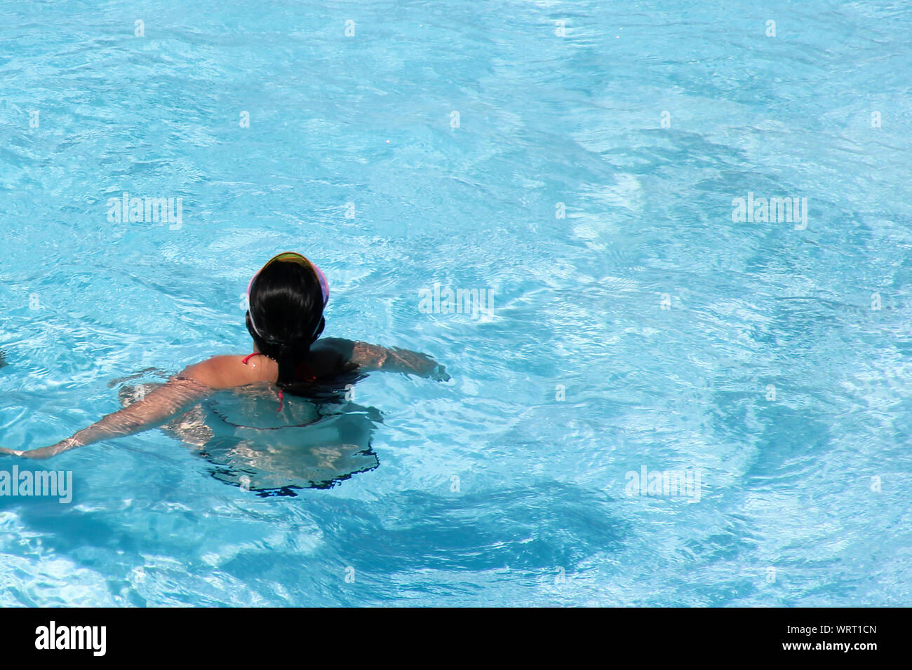 Rear view of woman swimming underwater hi-res stock photography and ...