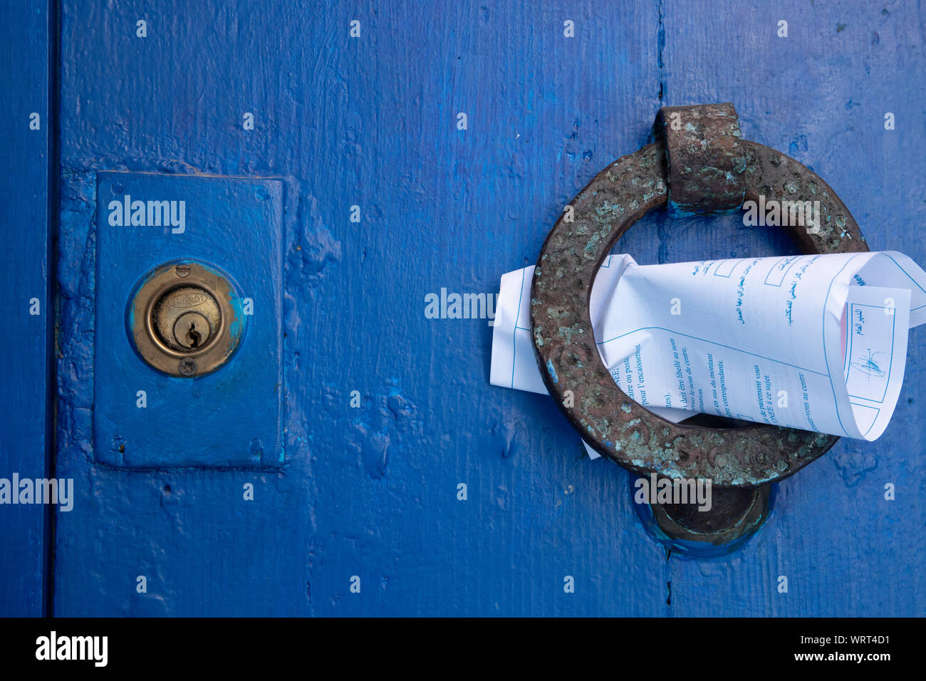 A bill is left in the door knocker in in Chefchaouen, Morocco Stock ...