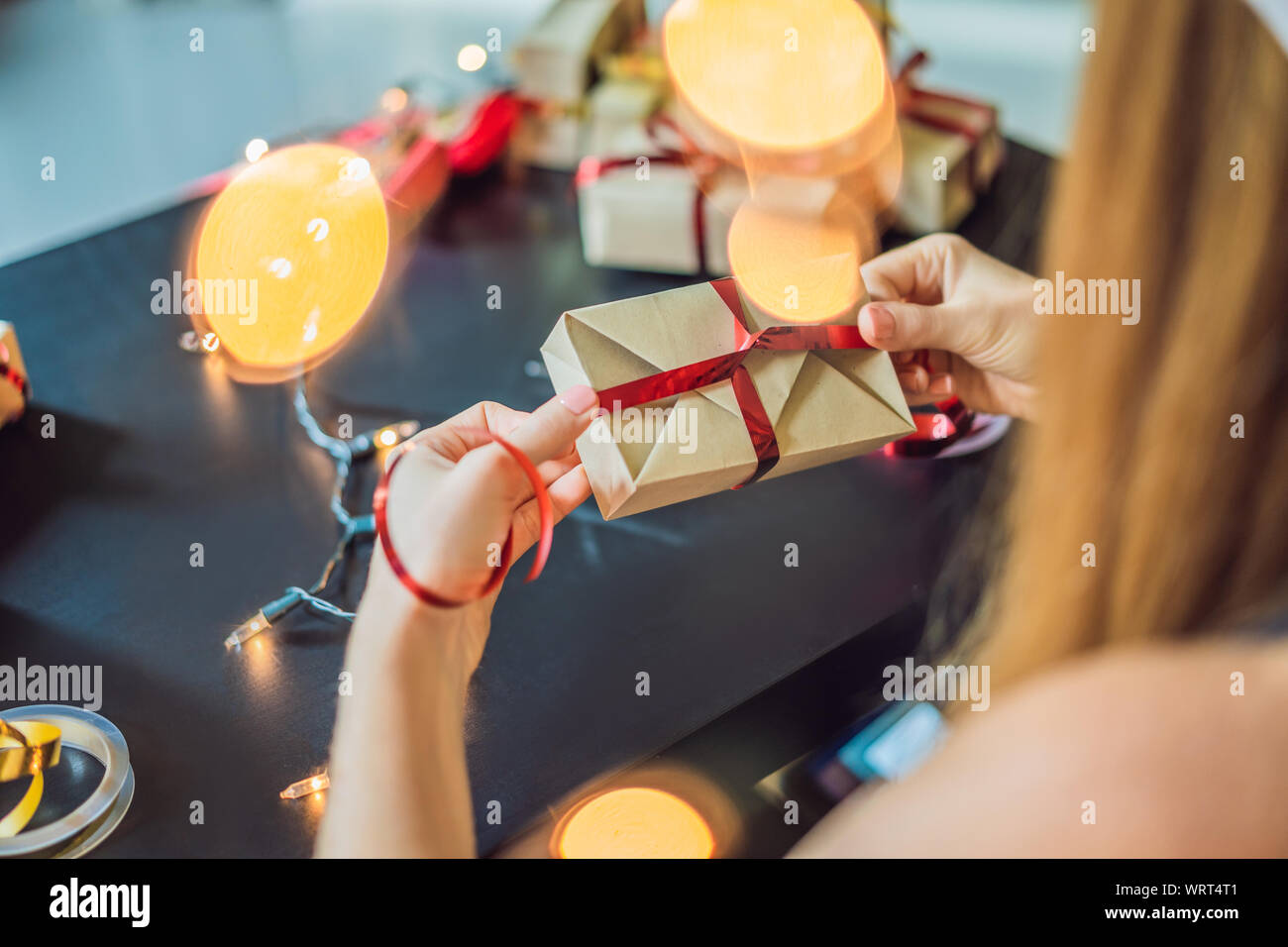 Woman wrapping present roll tape hi-res stock photography and images ...
