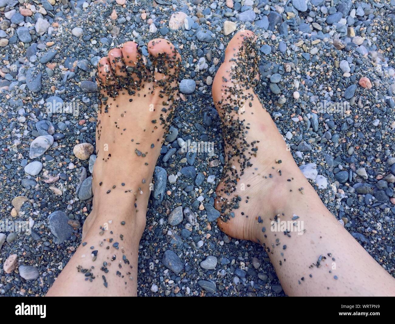 Close up of feet on stones hi-res stock photography and images - Alamy