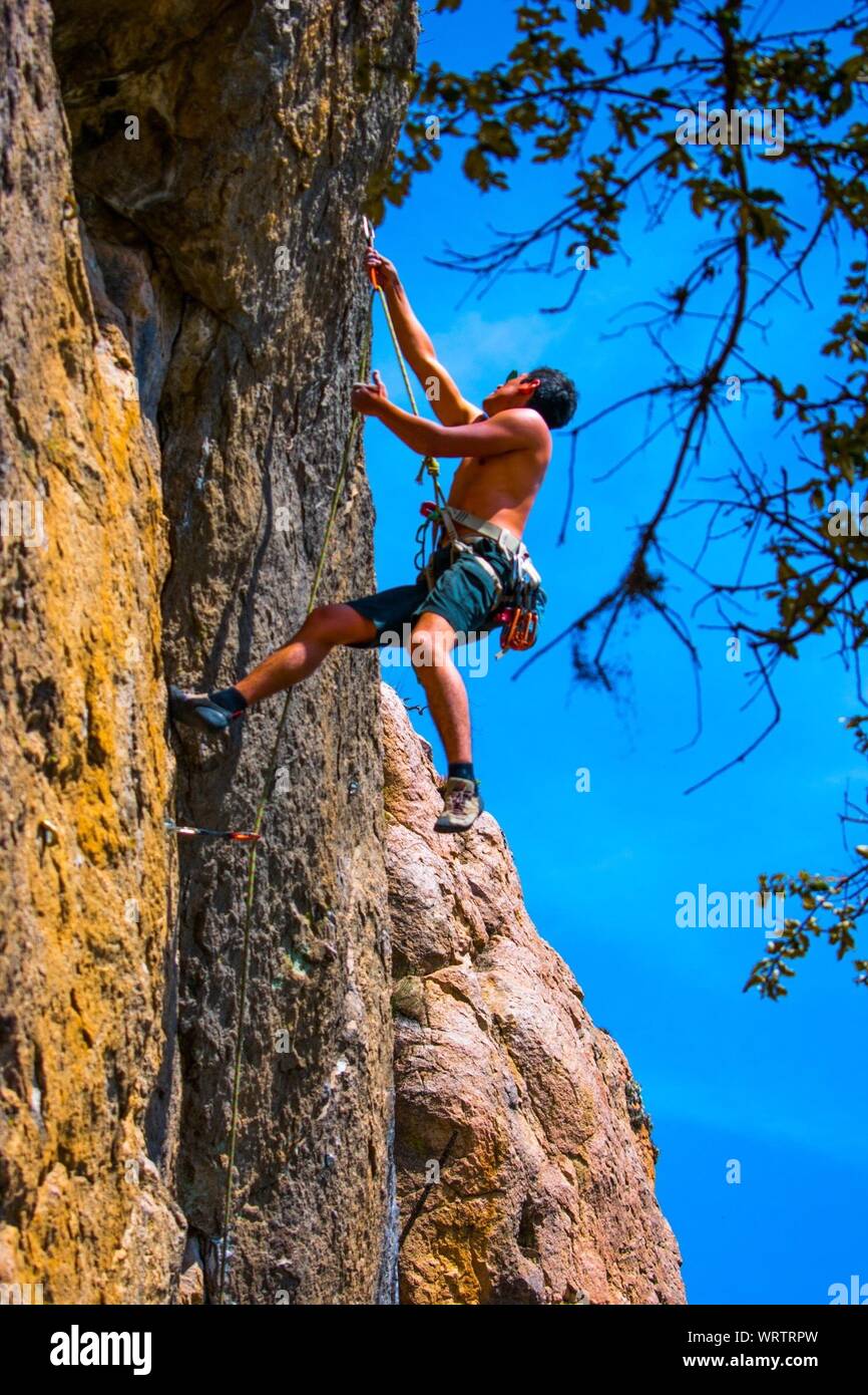 Man hanging on cliff hi-res stock photography and images - Alamy
