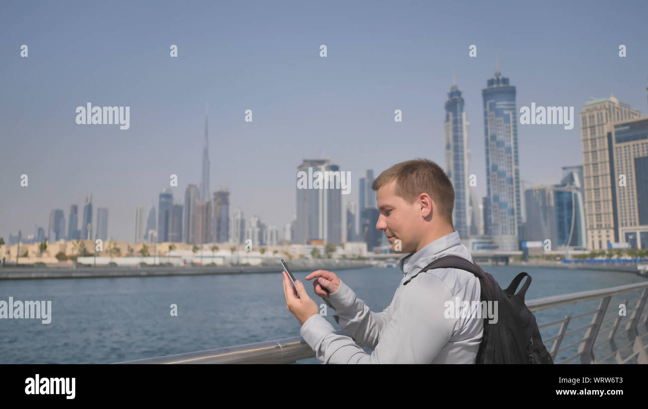 The man dials the number on the phone and talks on the background of ...