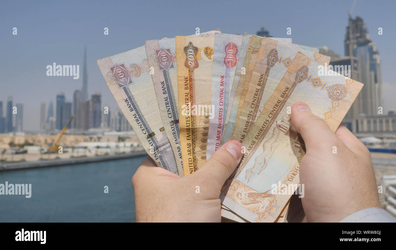The man recounts the money of the Arab emirates. Hand close-up Stock ...