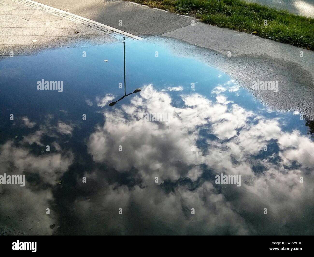 Rain puddle with cloud reflection hi-res stock photography and images ...