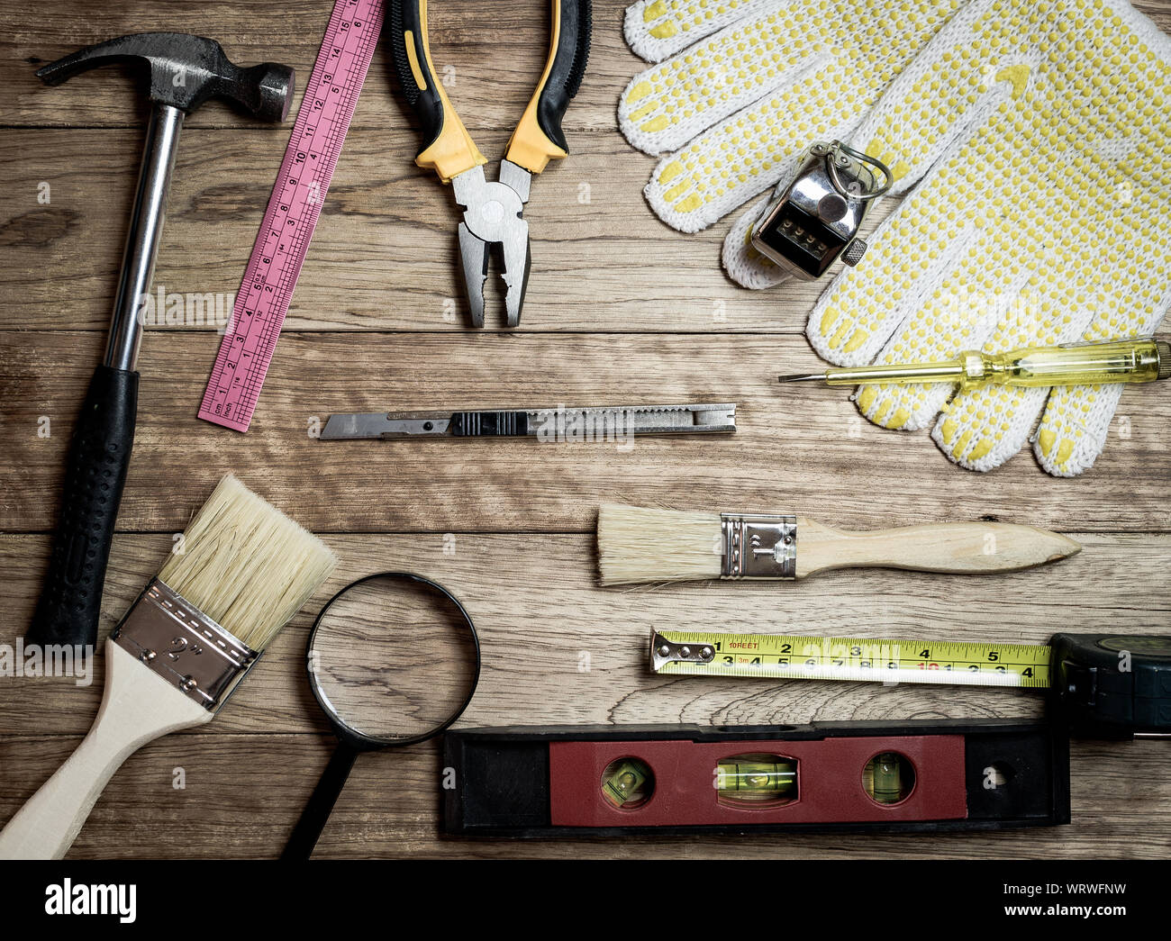 Set of tools over a wooden plank background Stock Photo - Alamy