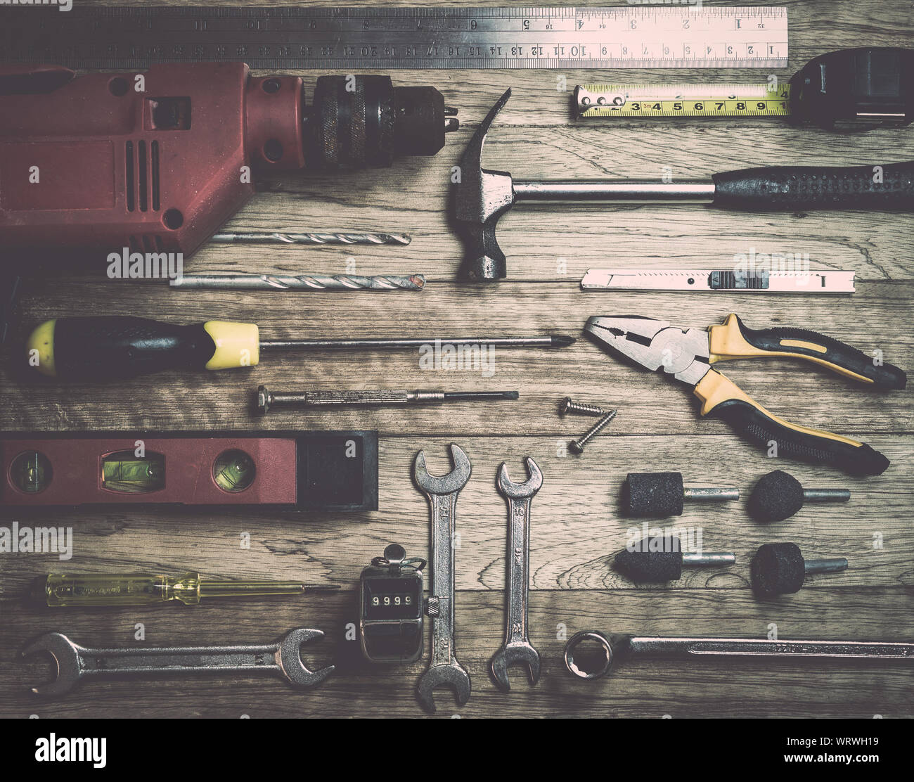 Set of tools over a wooden plank in vintage background Stock Photo - Alamy