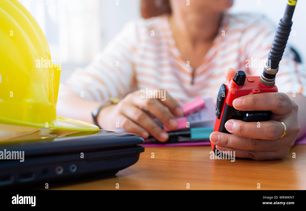 Female radio operator using Walkie - Talkie to communicate with other ...