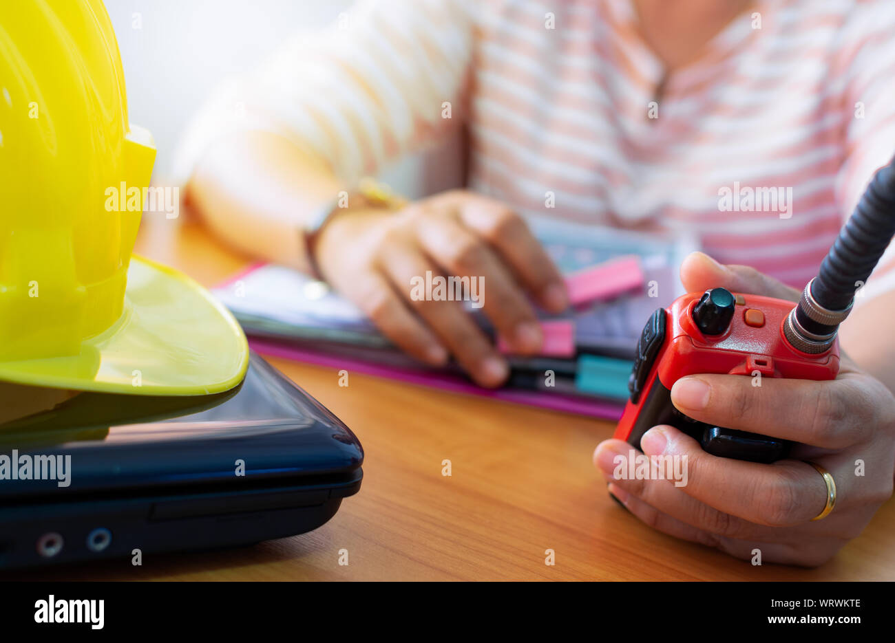 Female radio operator using Walkie - Talkie to communicate with other ...