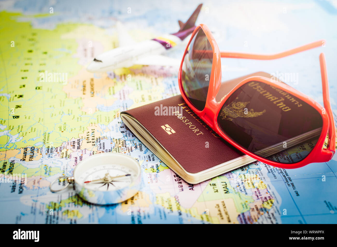Travel concept, Red sunglasses, passport, compass and aircraft on ...