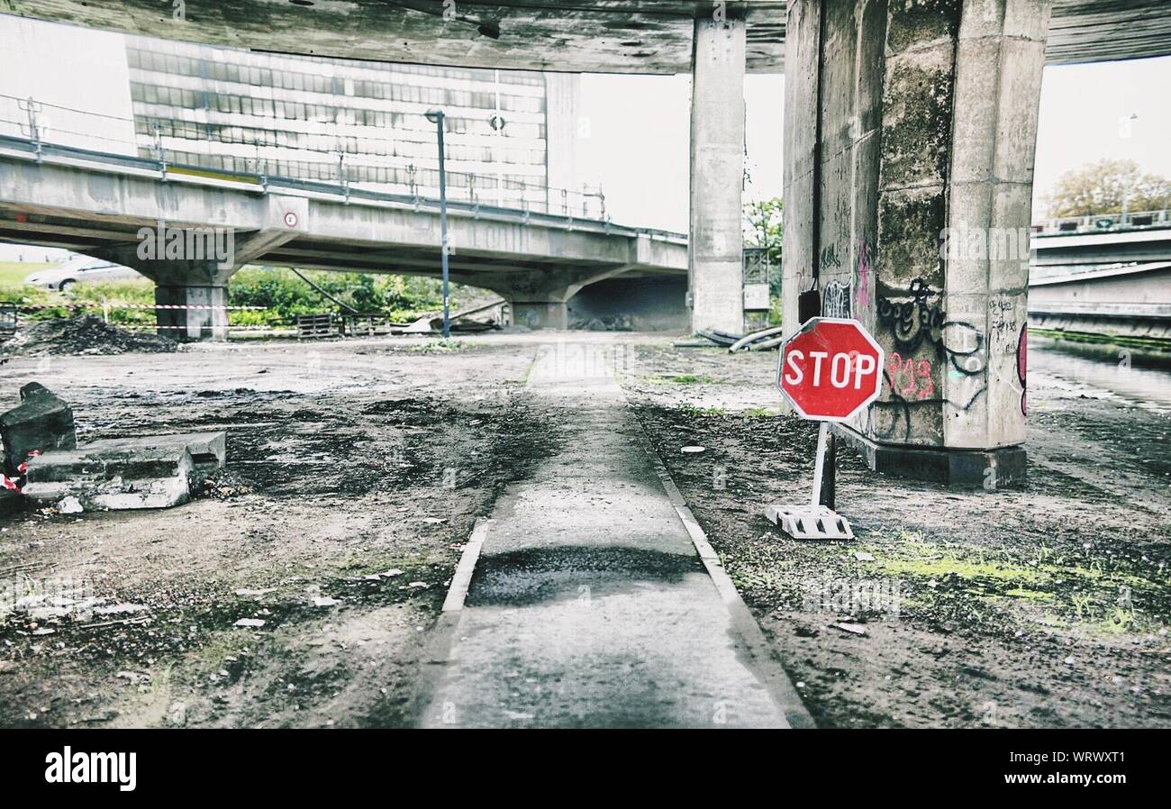 Stop Sign Below Old Bridge Stock Photo - Alamy