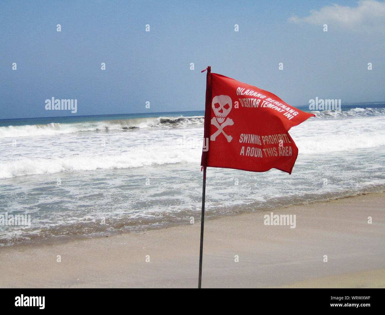 Beach With Blue Sky And Warning Sign Flag Stock Photo - Alamy