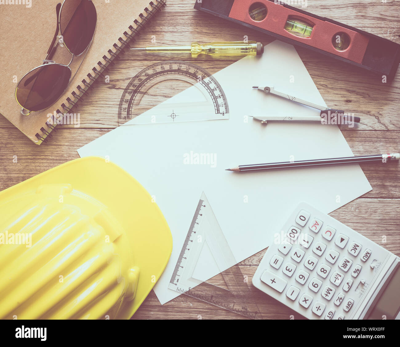 Paperwork with writing materials, construction helmet, sunglasses ...