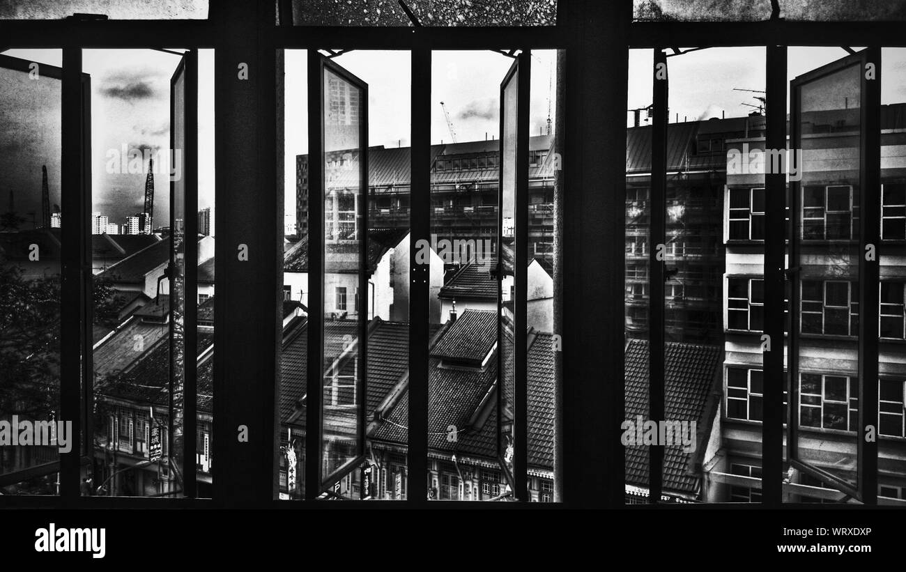 Buildings through window architecture Black and White Stock Photos ...