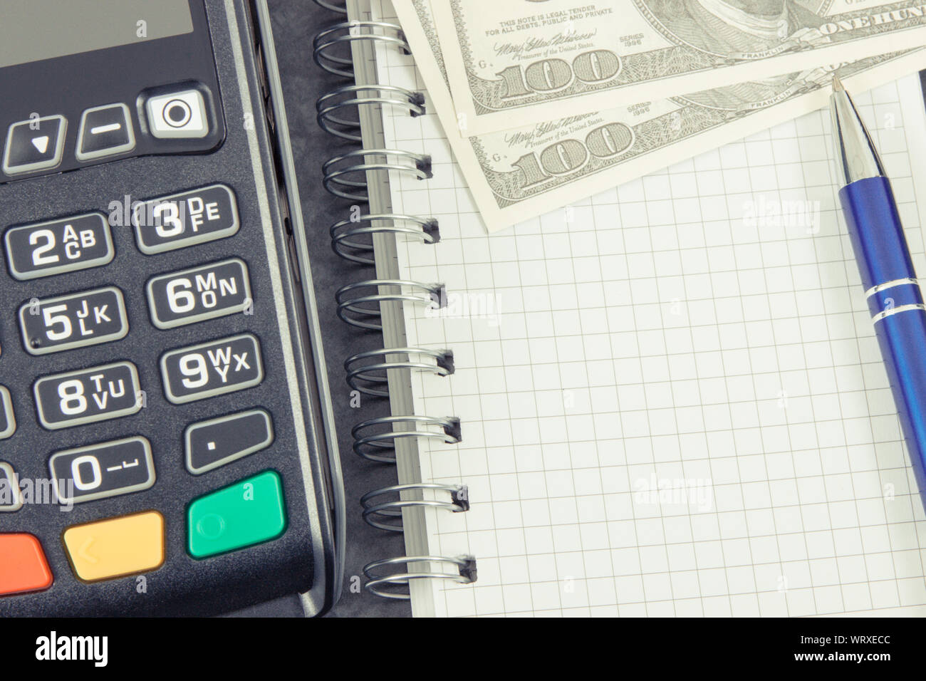 Payment terminal, notepad for writing notes and money. Business concept ...