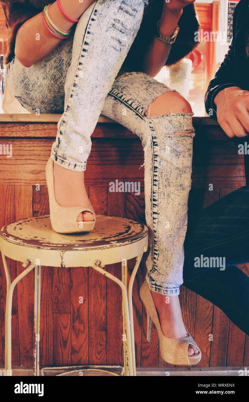 Woman sitting on bar stool High Resolution Stock Photography and Images ...