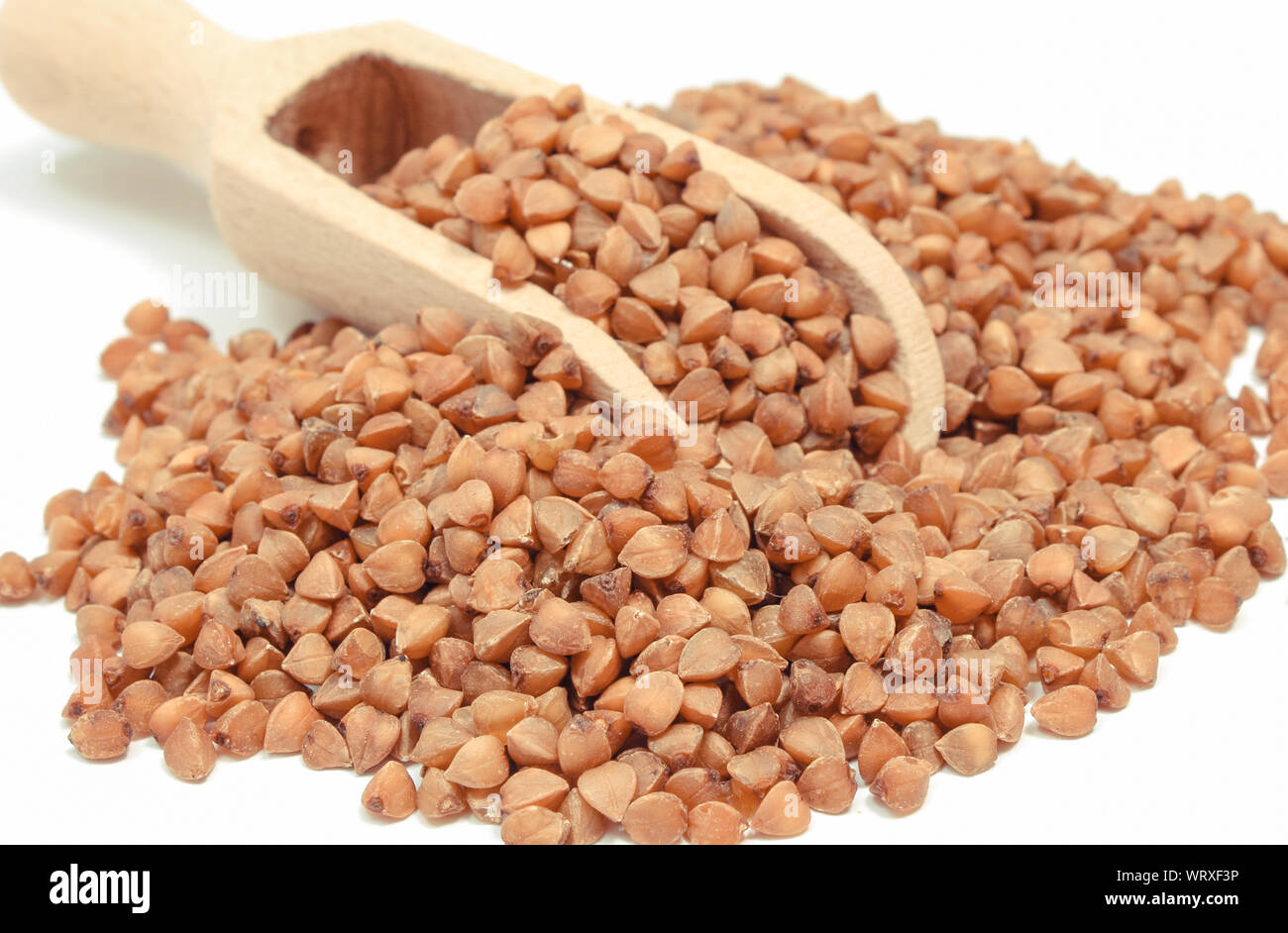 Buckwheat with wooden scoop. Food containing natural minerals and ...