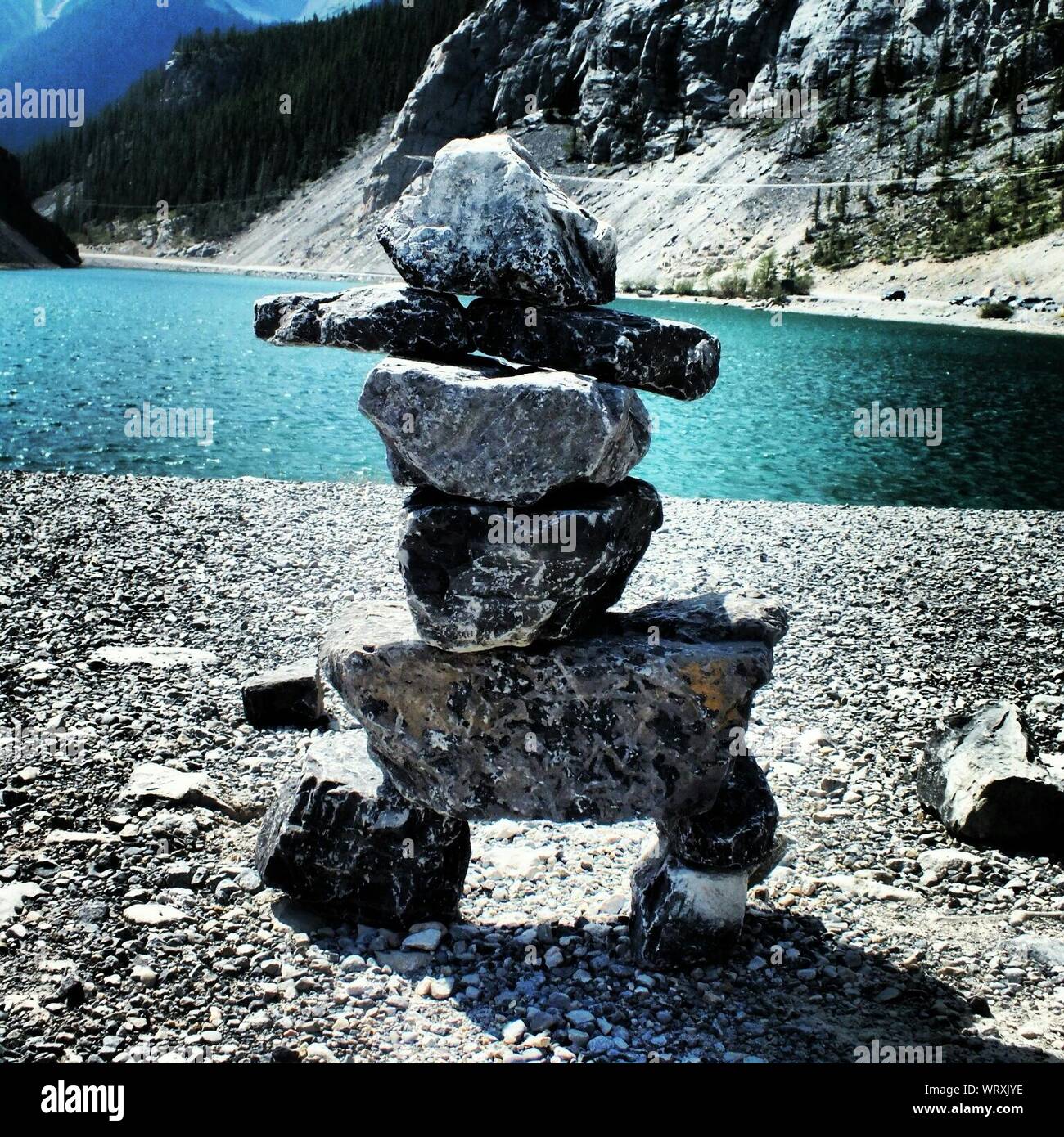 Stones Stacked On Lakeshore Stock Photo - Alamy