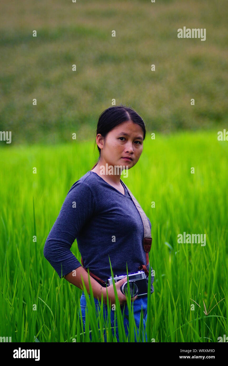 Portrait of a woman walking in a rice field photo Stock Photo - Alamy