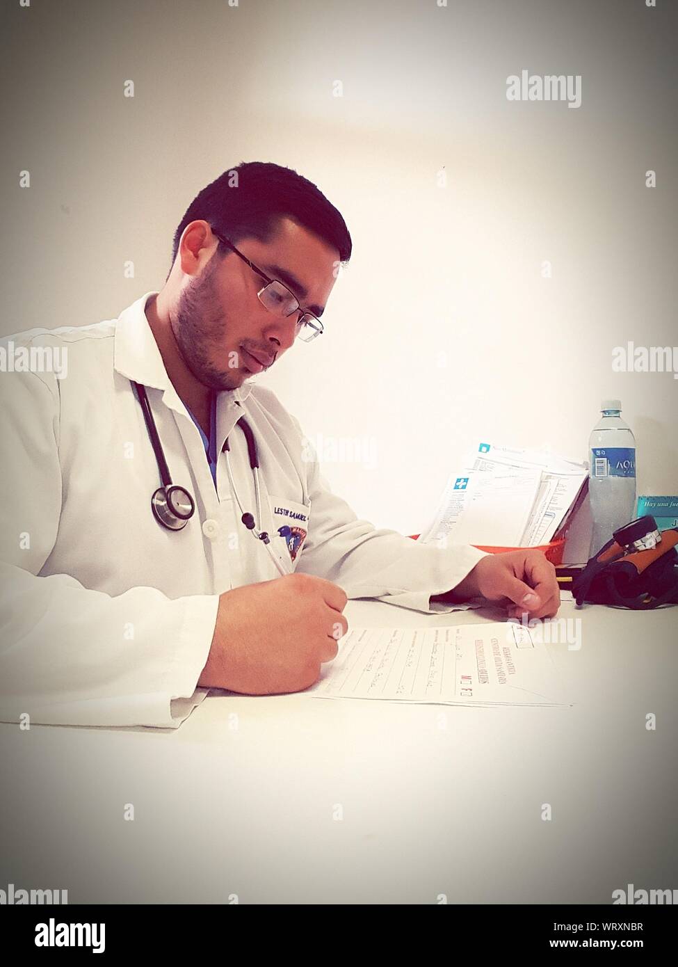 Indian doctor writing hi-res stock photography and images - Alamy