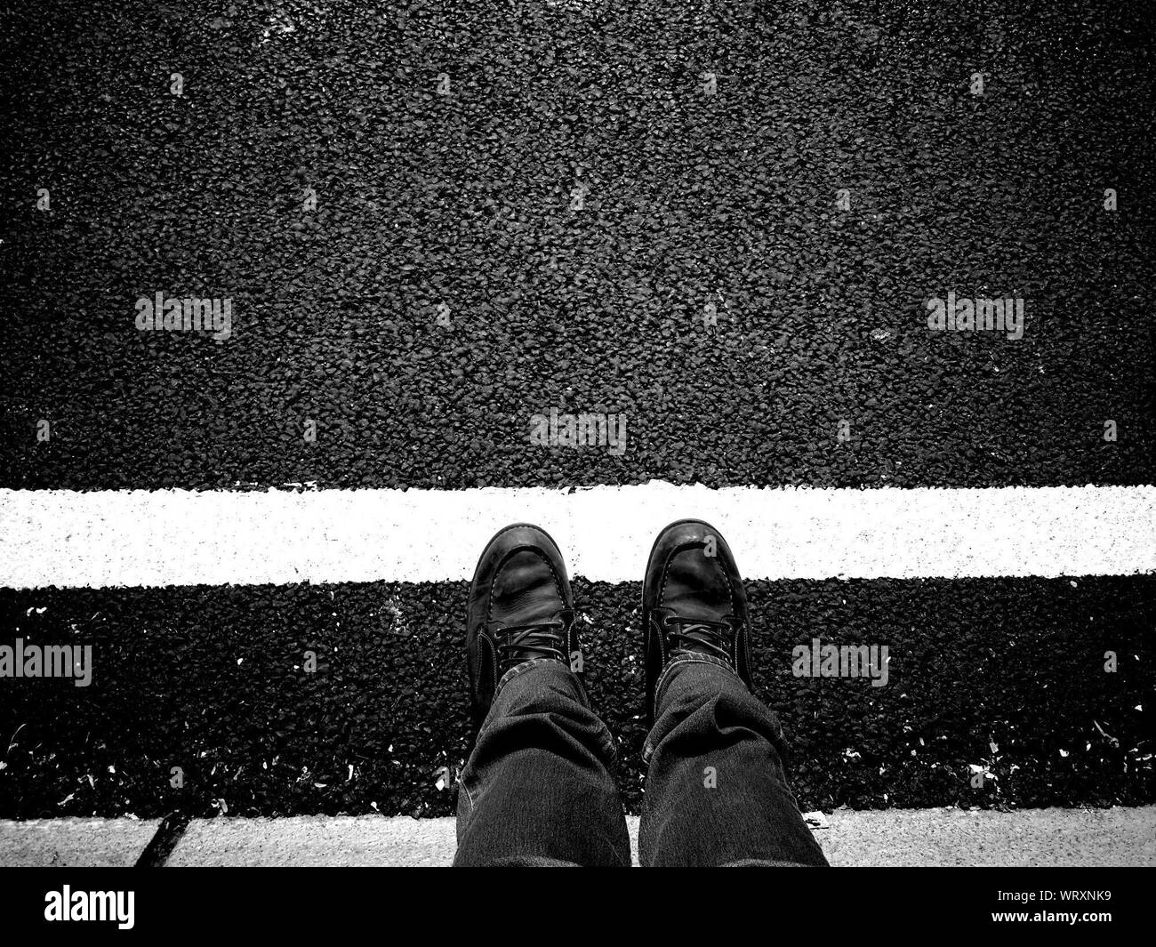 Man crossing road crossing Black and White Stock Photos & Images - Alamy
