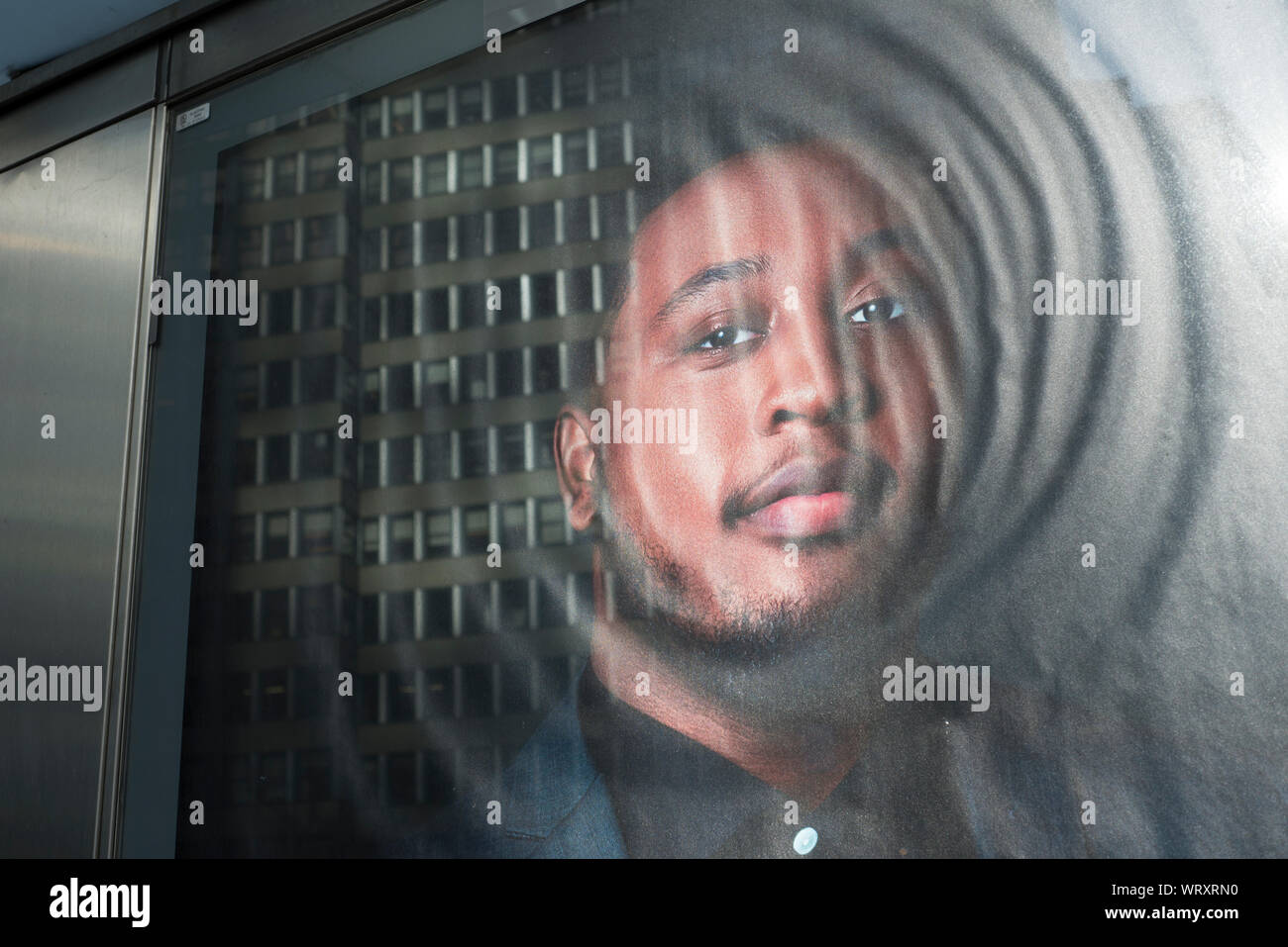 A warped / water damaged sign on the side of a sidewalk vendor's stand ...