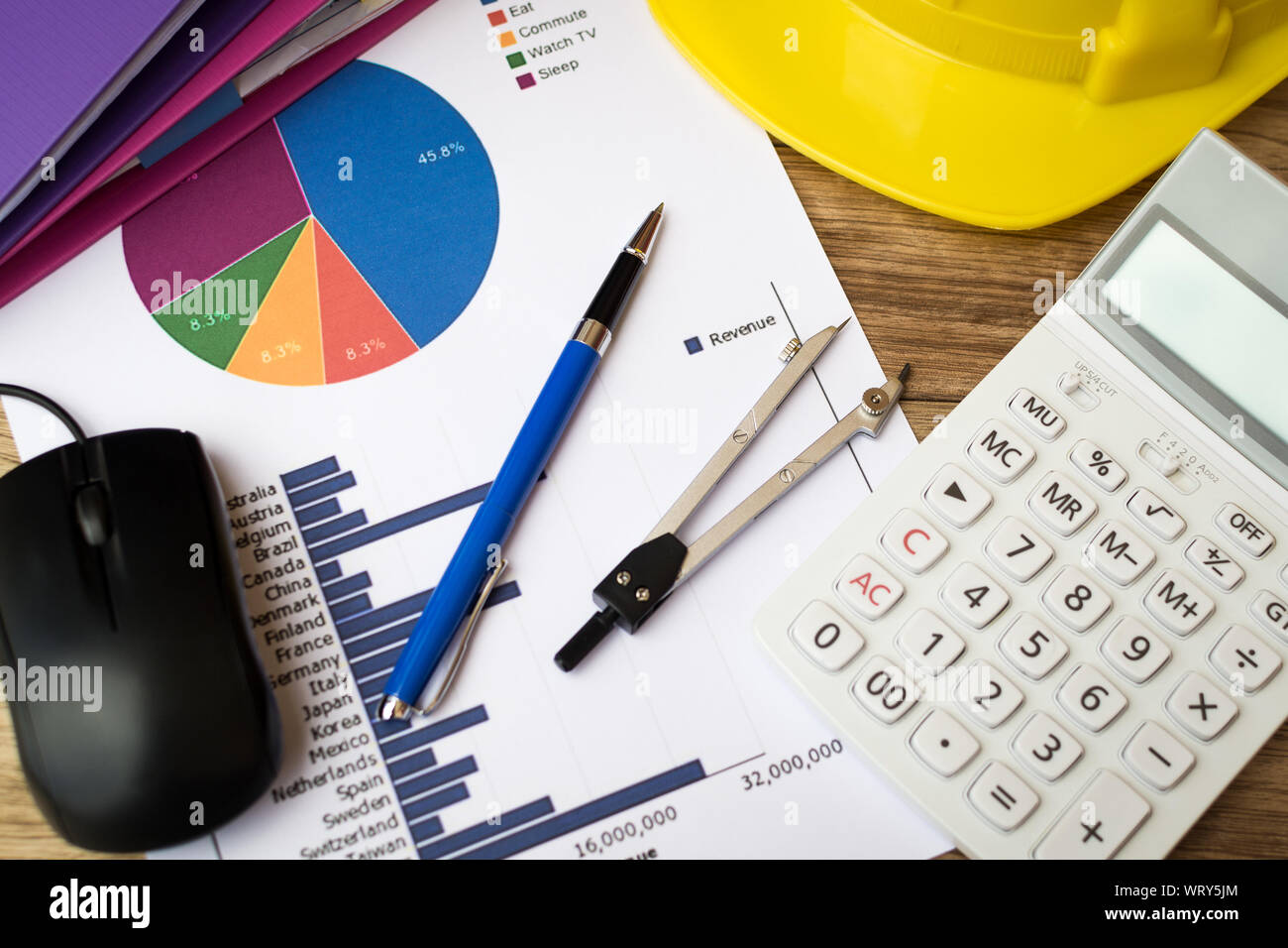 Finance graph with pen, construction helmet, calculator and other on ...