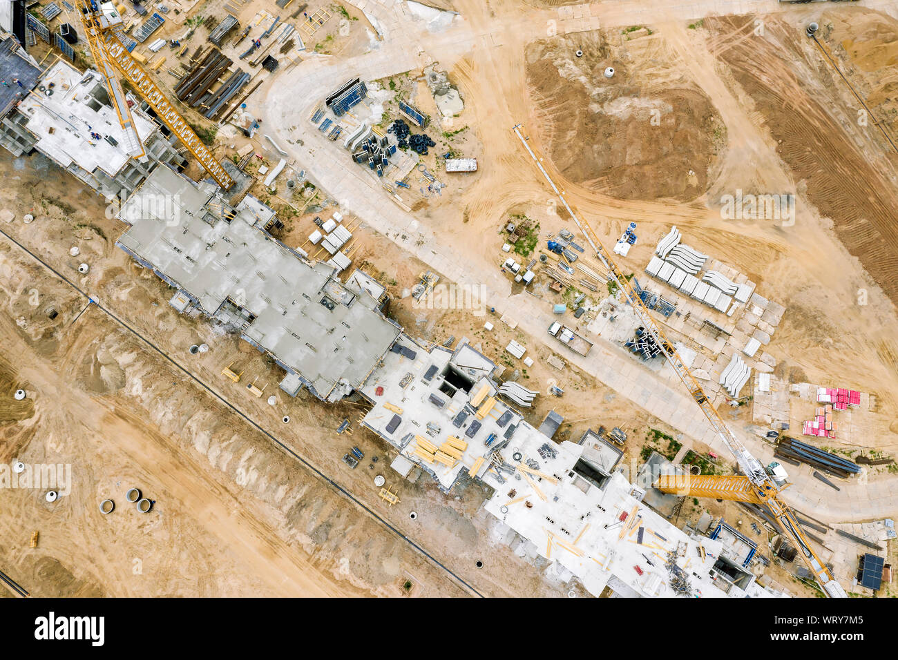 aerial top view of yellow tower cranes working at construction site ...