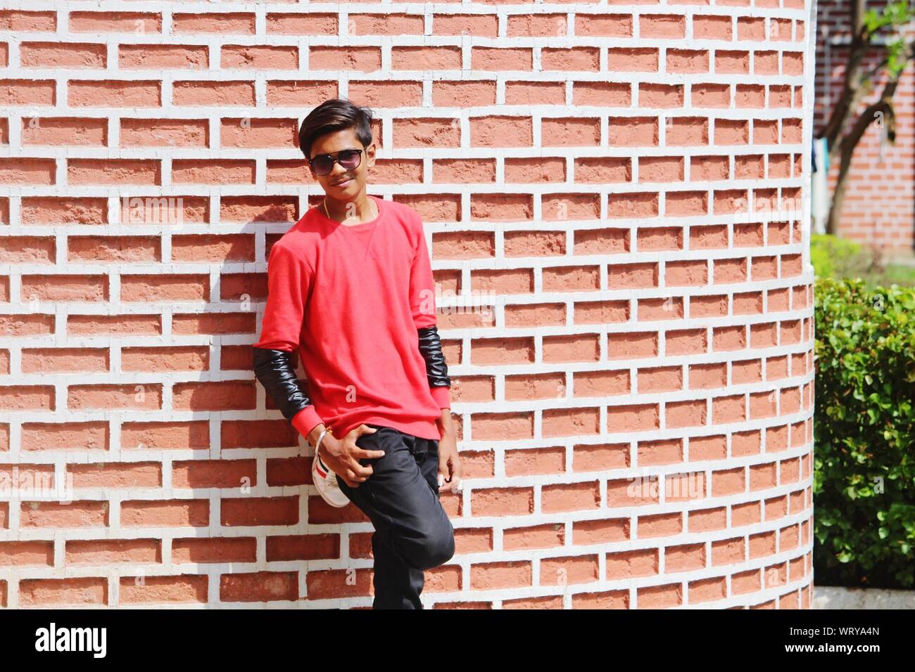 Red brick wall man standing hi-res stock photography and images - Alamy