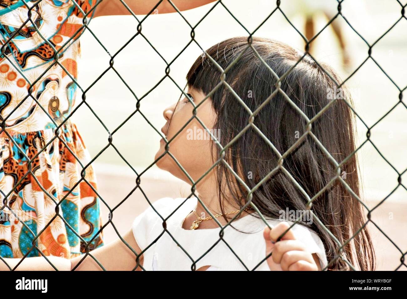 Girl Looking Through Fence High Resolution Stock Photography and Images ...
