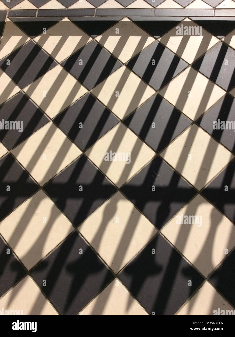 Shadow Falling On Tiled Floor Stock Photo - Alamy