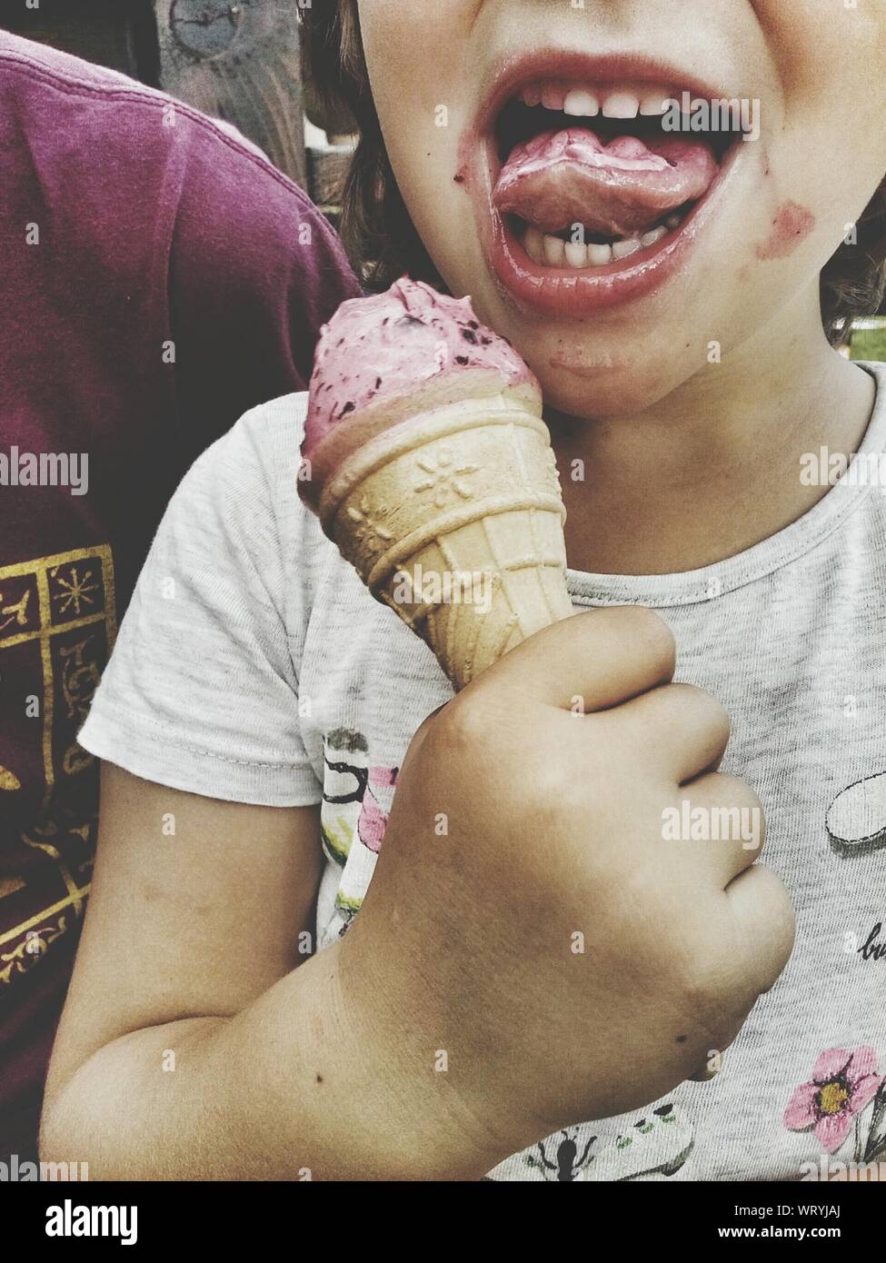 Girl eating messy ice cream hi-res stock photography and images - Alamy