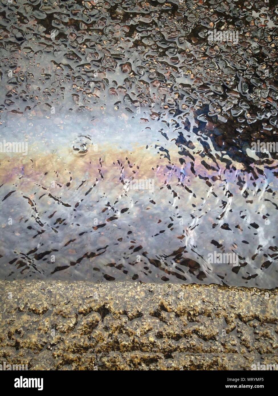 Oil spill rain water High Resolution Stock Photography and Images - Alamy