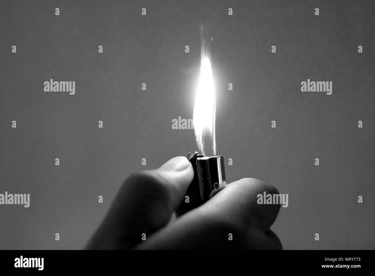 Hand holding lighter cigarette lighter Black and White Stock Photos ...