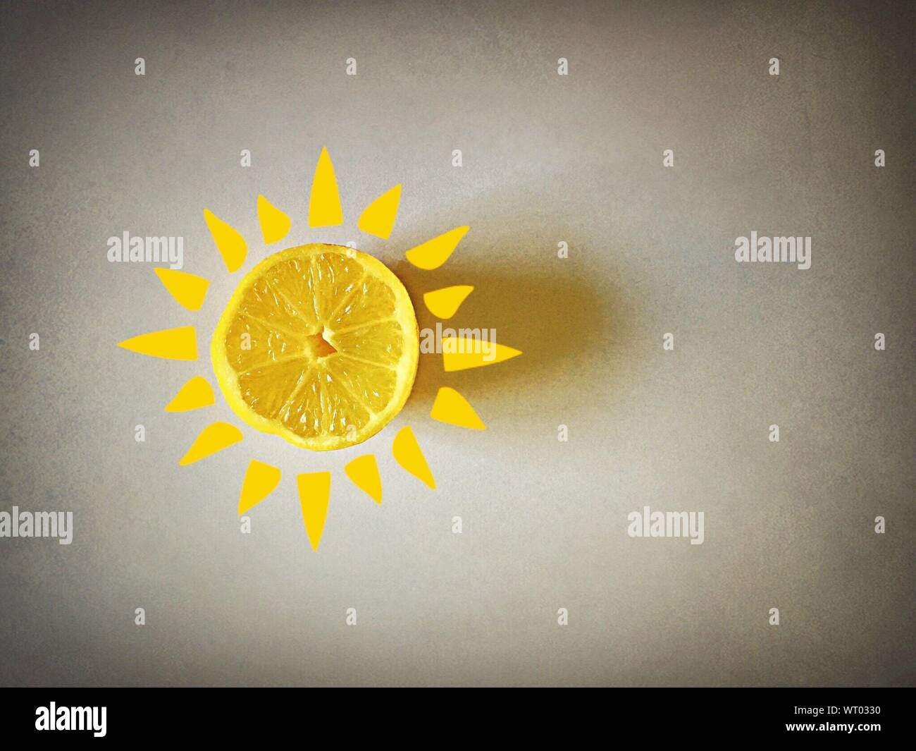 Optical Illusion Of Sun Made From Lemon On Table Stock Photo - Alamy