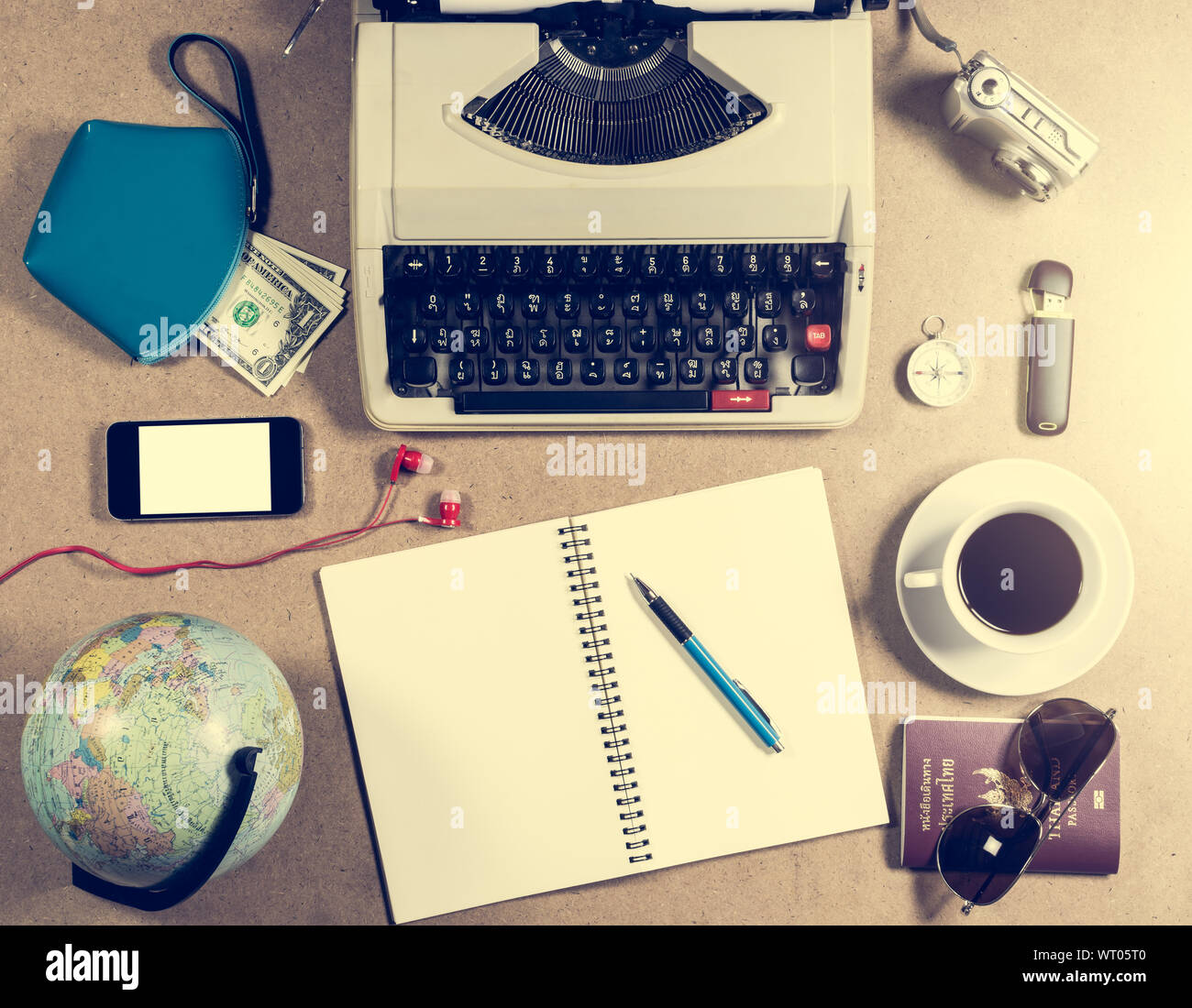 Typewriter and personal items under light on the vintage table Stock ...