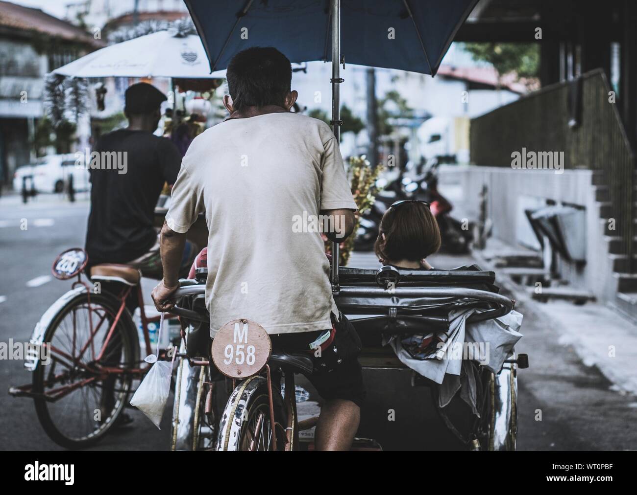 Man riding tricycle hi-res stock photography and images - Alamy