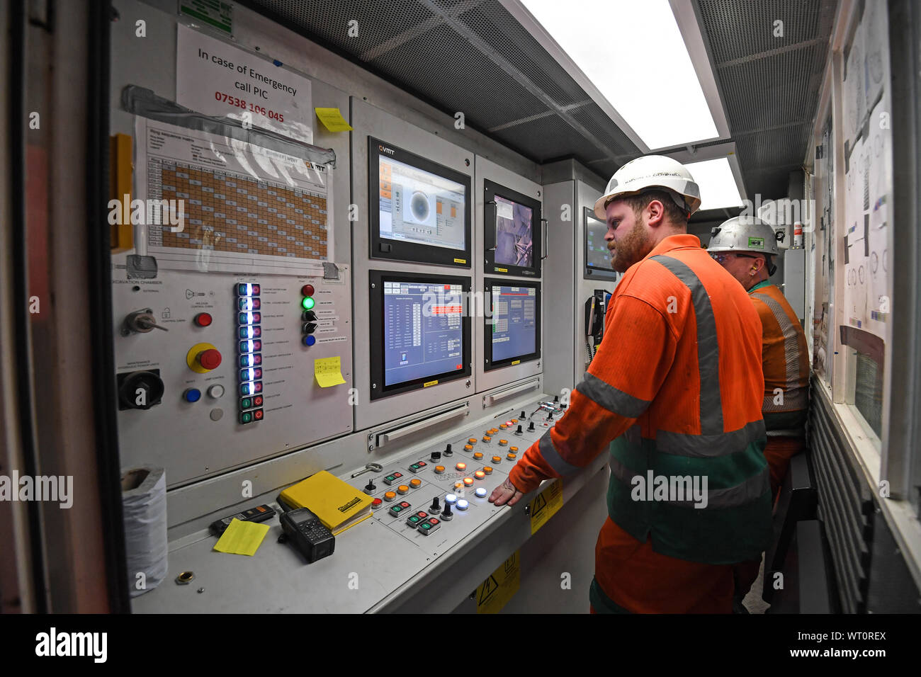 Engineers inside the control room of a Boring machine excavating a ...