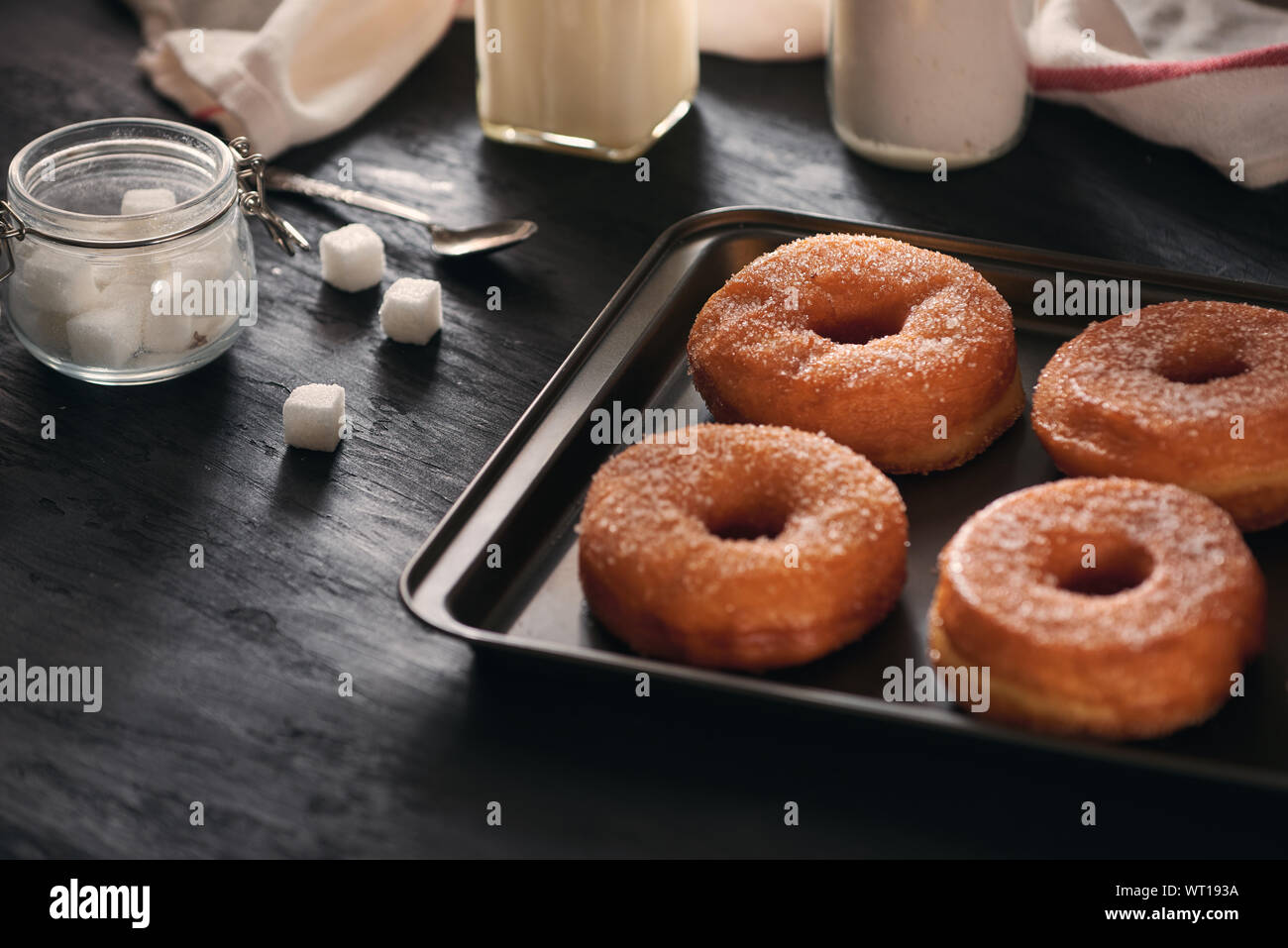 White sugar donuts on a sheet metal tray Stock Photo - Alamy