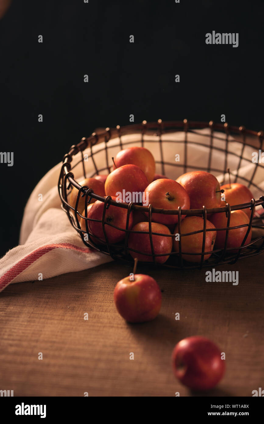 Sweet mini apples in a basket ready for eat over black background Stock ...