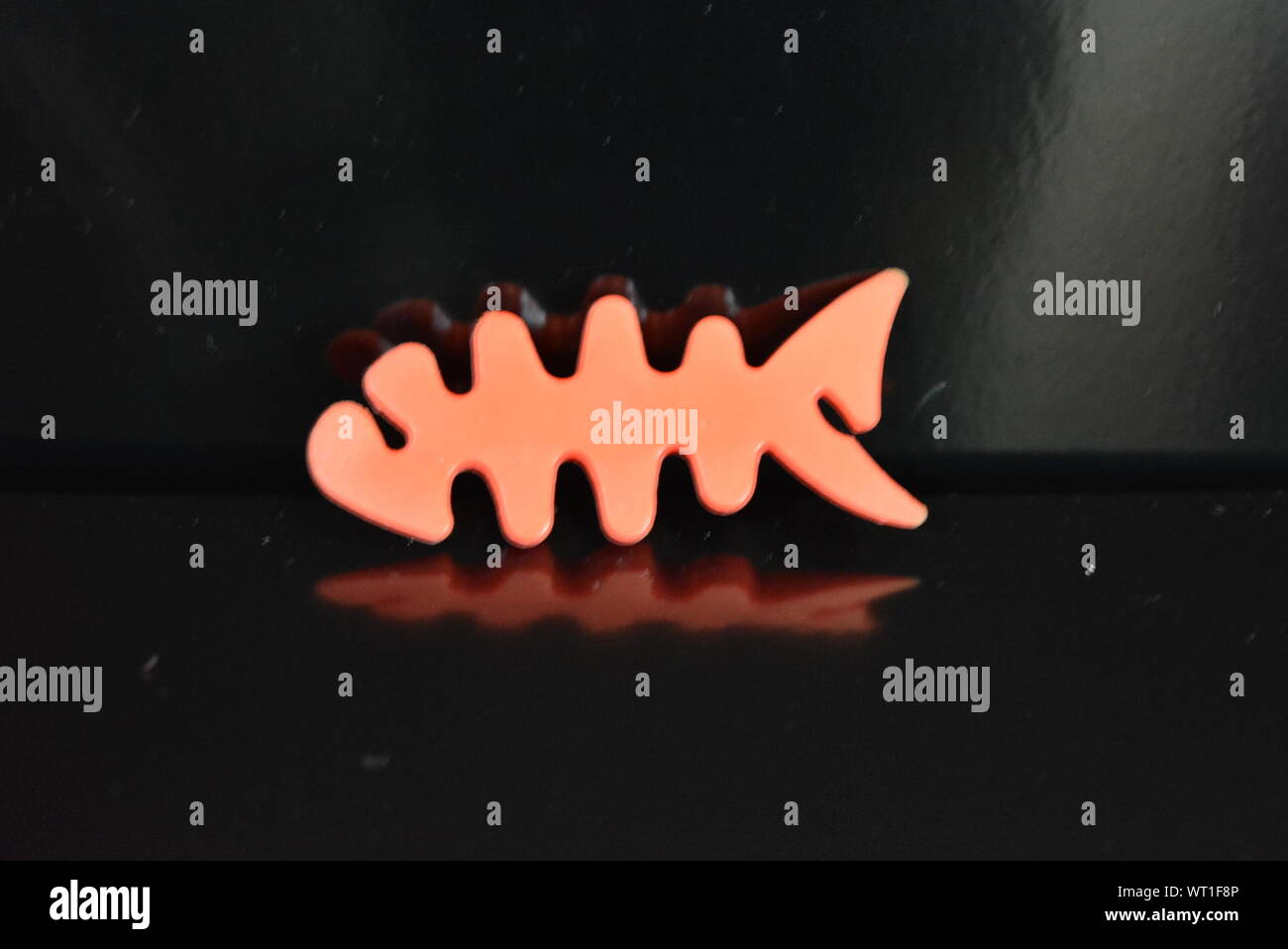 Red rubber plastic fish for wrapping headphones and a headset, reducing ...